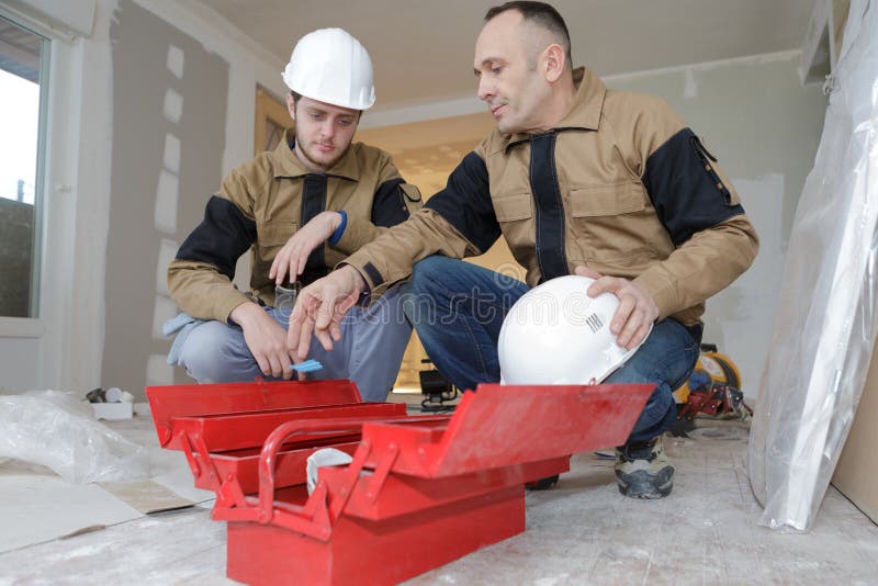 Builders Talk About Blueprint On Bench Stock Photo - Image of hard ...