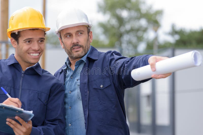 Builders in Helmets Pointing Outdoors Stock Image - Image of profession ...