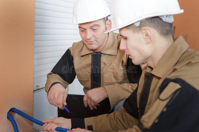 Builders Holding Hose Pipe Insulation on Hot Water Pipes Stock Photo ...