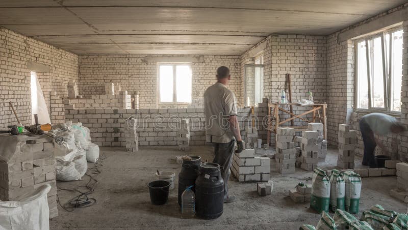 Builders Laying Brick Walls Inside Appartment with Professional ...
