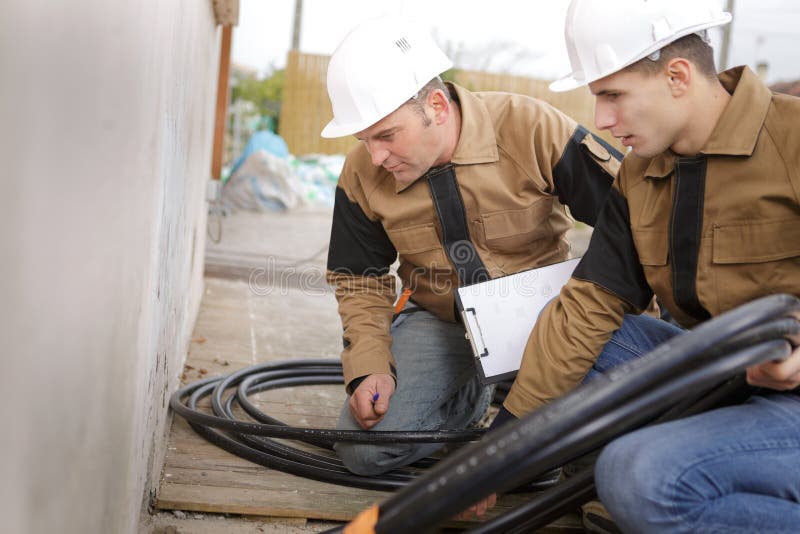 Builders with Pipes Outside Construction Site Stock Image - Image of ...