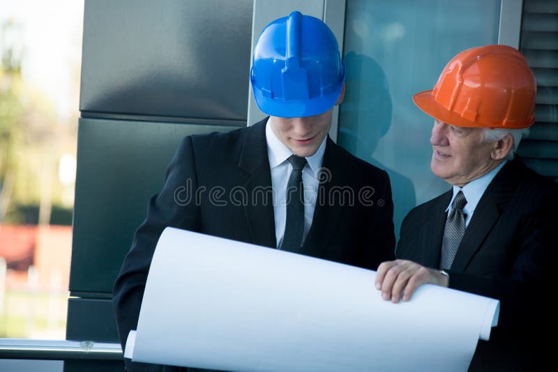 Builders planning the job stock photo. Image of handsome - 47381124