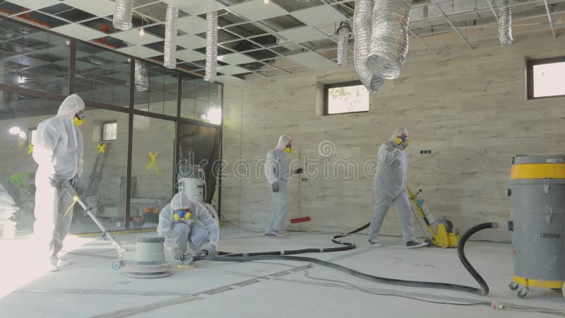Concrete Surface Grinding. Builders at a Construction Site. Builders ...