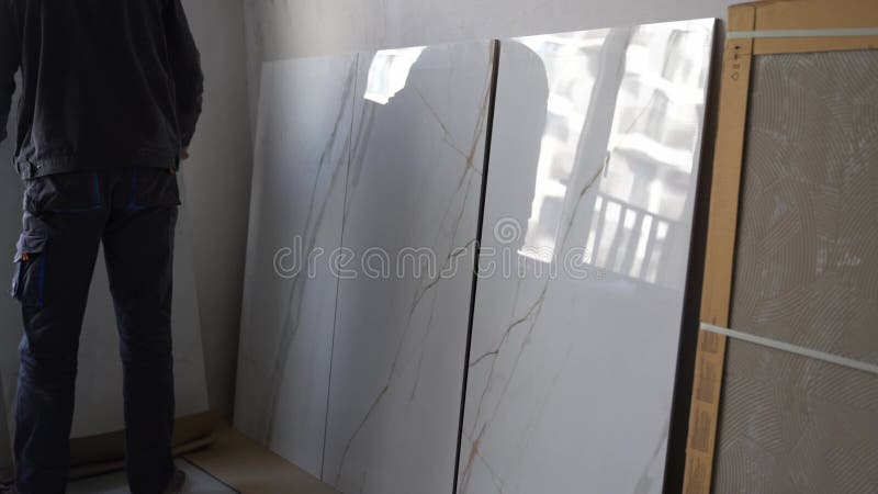 Builders are Putting Up a Row of Large-format Tiles Measuring 120 by 60 ...