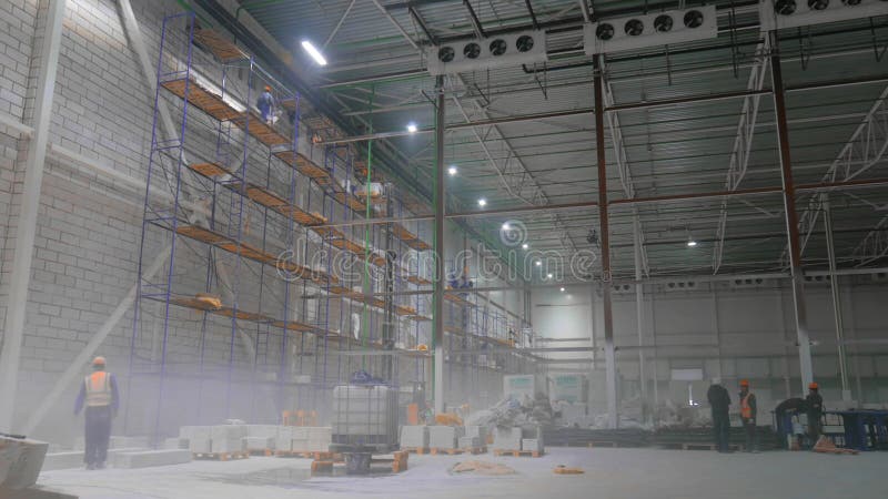 Builders on Scaffolding Inside Large and Modern Warehouse Under ...