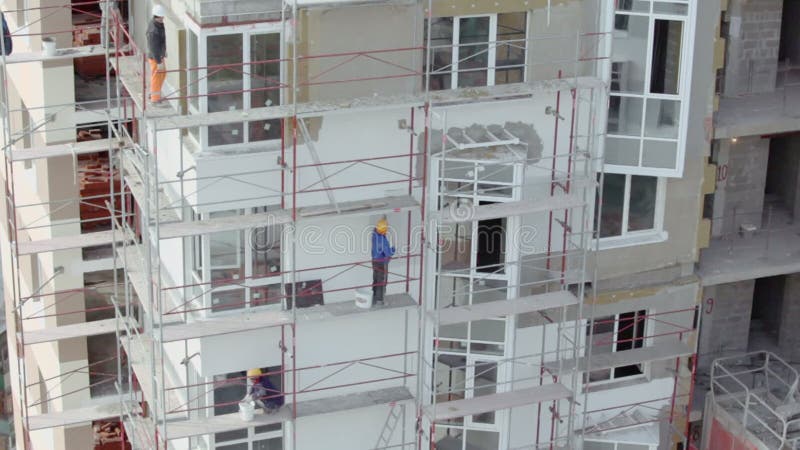 Builders Stand on Scaffold and Make Stock Video - Video of motion, male ...
