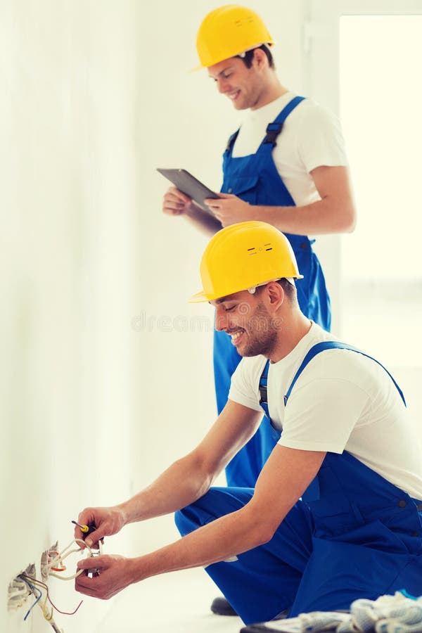 Builders with Tablet Pc and Fixing Wiring Indoors Stock Photo - Image ...