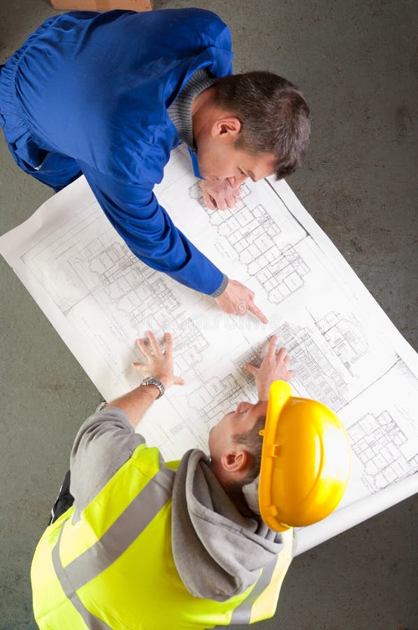 Two Builders Discuss Construction Blueprints Stock Photo - Image of ... Two Builders Discuss Construction Blueprints Stock Photo - Image of ...