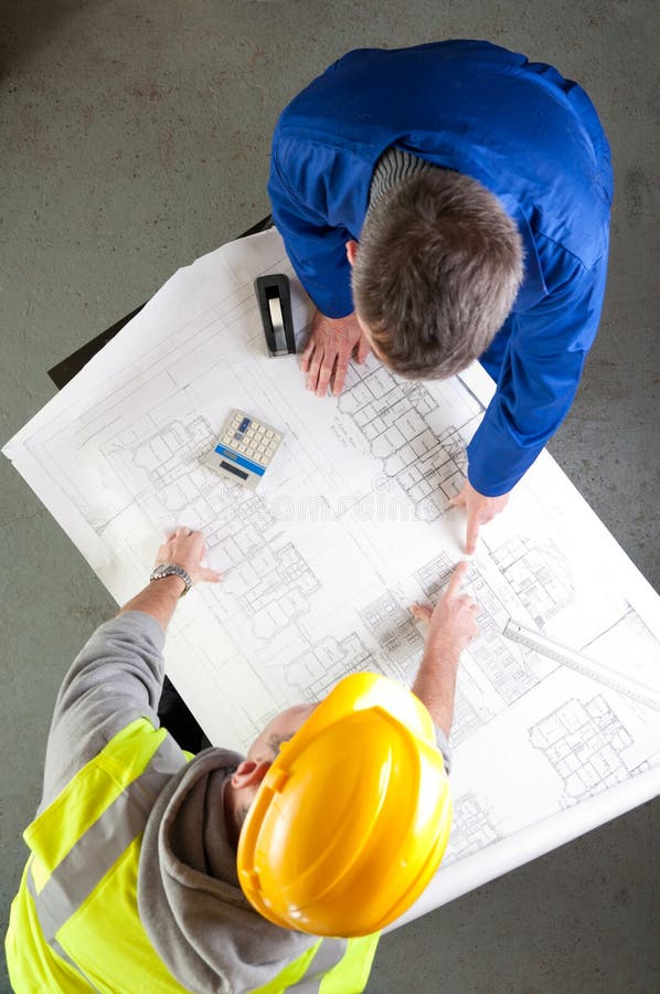 Two Builders Discuss Construction Blueprints Stock Photo - Image of ... Two Builders Discuss Construction Blueprints Stock Photo - Image of ...