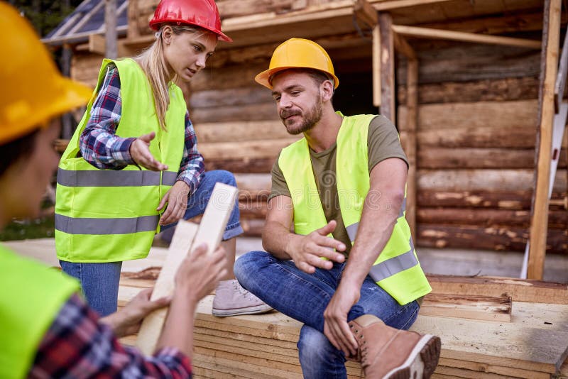 Builders are Talking at the Cottage Construction Site in the Forest ...
