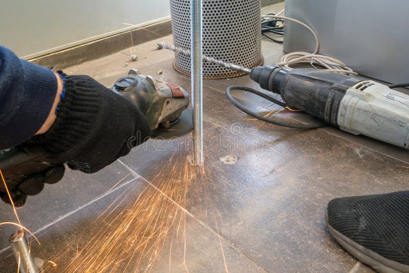 Builders Use a Grinder To Cut Off the Desired Length of an Iron ...