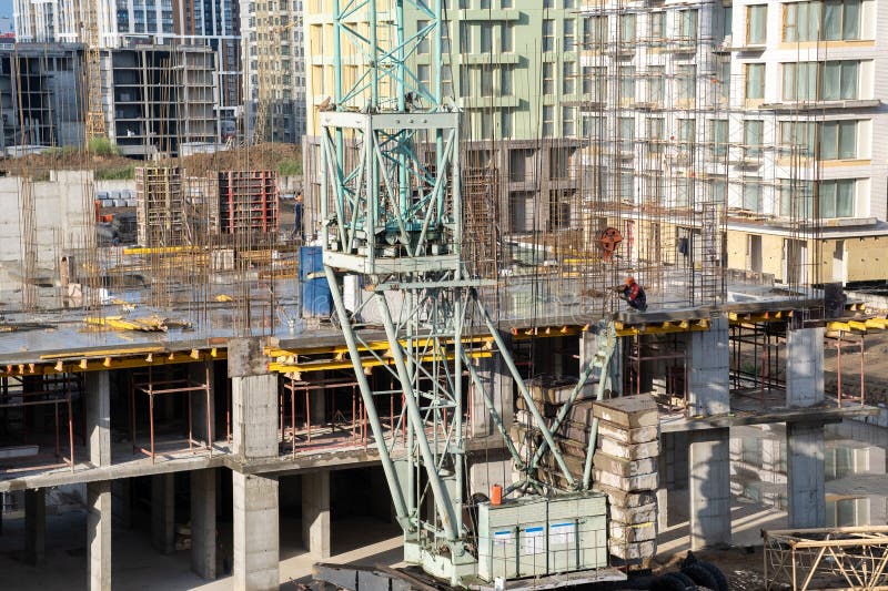 Builders Work on Large Construction Sites, and There are Many Cranes ...