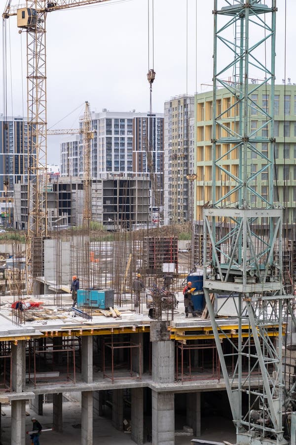 Builders Work on Large Construction Sites, and There are Many Cranes ...