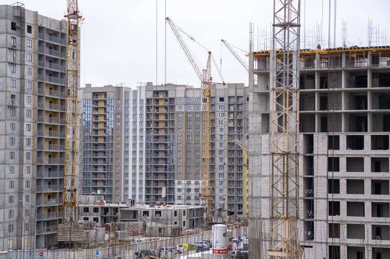 Builders Work on Large Construction Sites, and There are Many Cranes ...