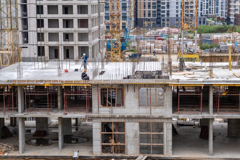 Builders Work on Large Construction Sites, and There are Many Cranes ...