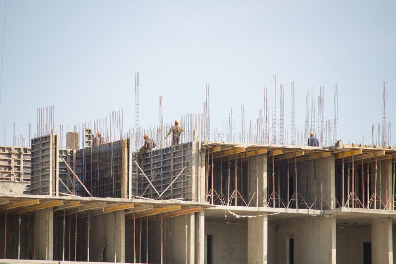 Builders Working on the Construction of a Large Building Stock Photo ...