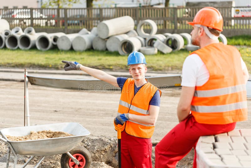 Builders working together stock image. Image of equipment - 70681565