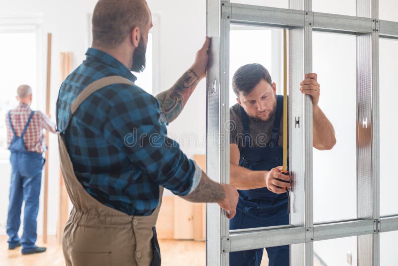 Builders working together stock image. Image of business - 171982543