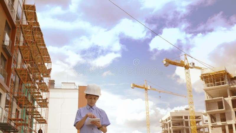 Building Adventures: Boy in Construction Helmet on a Construction Site ...