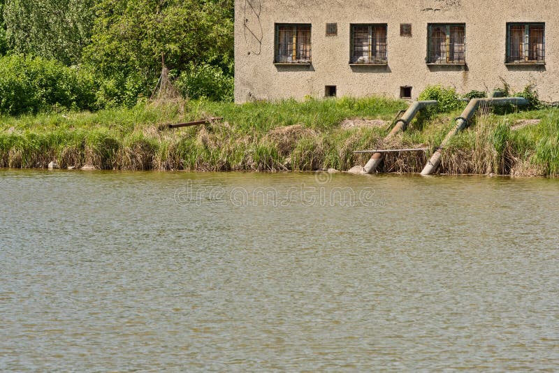 Building Along the River and Pipes Stock Photo - Image of sewer ...