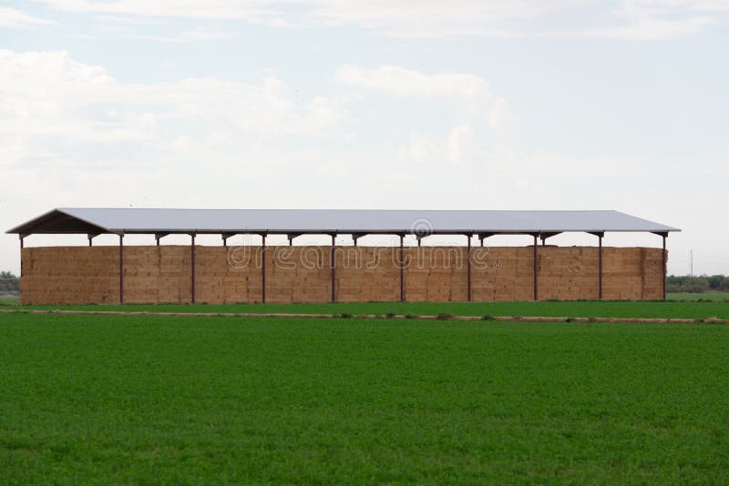 Building with Bales of Hay Surrounded by Green Fields Stock Image ...