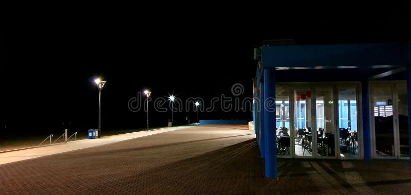 Building by the Beach Captured at Night with the Switched on City ...