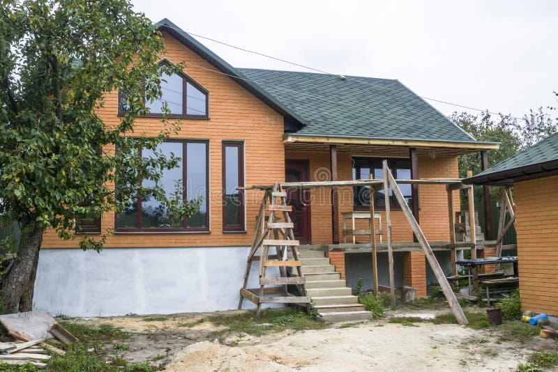 Building Brick House Outside the City. Foreground with Scaffolding ...