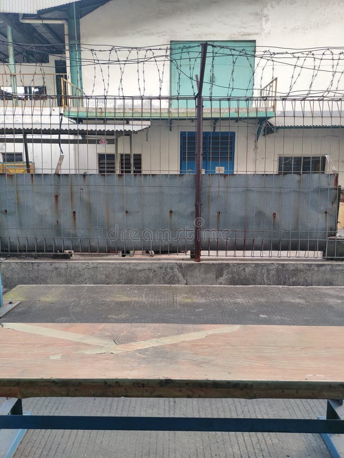 A Building or Buildings that are Separated by a Fence and Zinc Stock ...