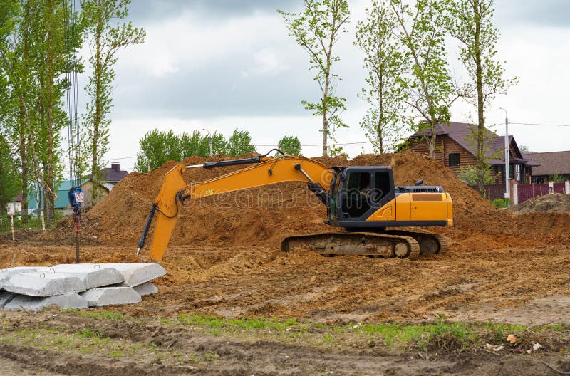 An Excavator is Digging a Pit for a House. Stock Image - Image of ...