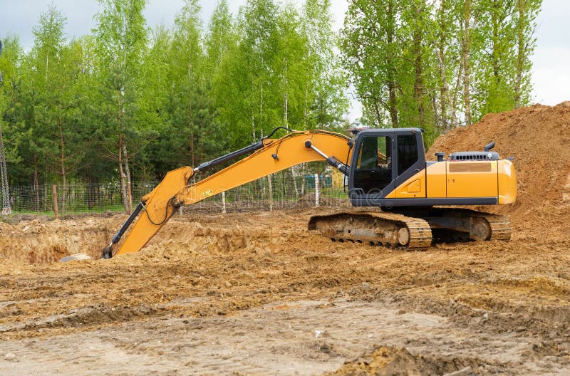 An Excavator is Digging a Pit for a House. Stock Photo - Image of ...