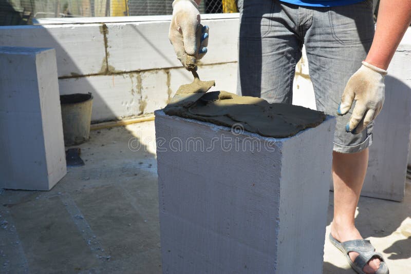 Building a Concrete Block Wall. the Contractor is Laying Concrete ...