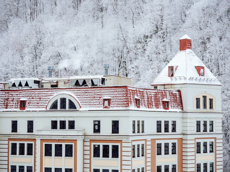 Building with a Cone Tower Against a Background of Snow-covered Trees ...