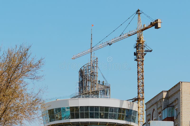 Building Construction and Crane Against the Blue Sky. Metal Structures ...
