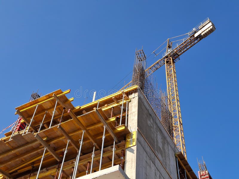 A Building during Construction and a Crane Next To it. Construction ...