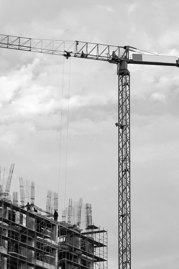 Building In Construction And A Hoisting Crane. Stock Photo - Image of ...