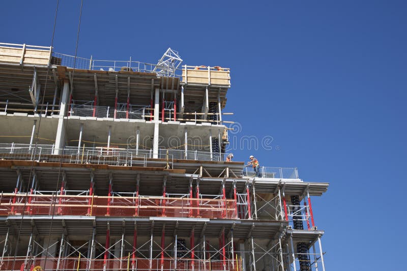 Building Construction Site with Scaffolding and Construction Worker ...