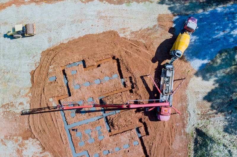 Building Construction Worker Pouring Concrete To Foundation of the ...