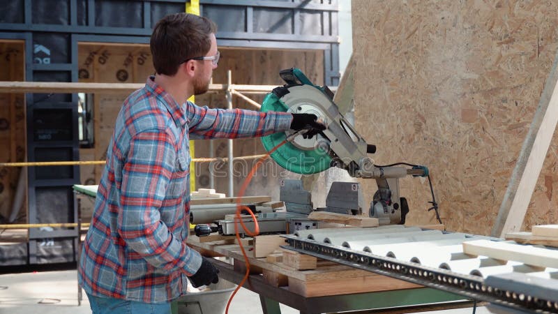 Building Contractor Worker Using Hand Held Worm Drive Circular Saw To ...