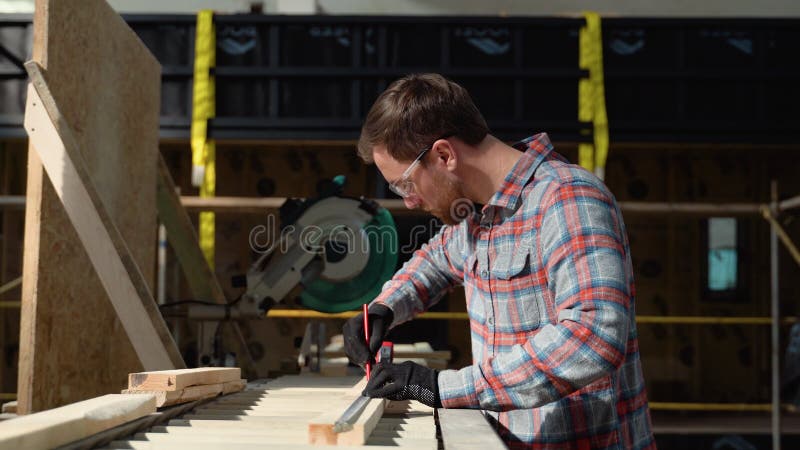 Building Contractor Worker Using Hand Held Worm Drive Circular Saw To ...