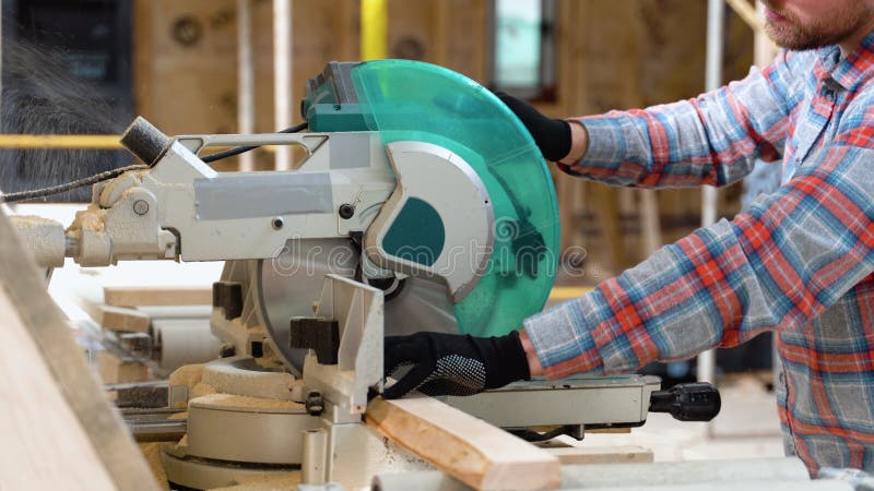 Builder Saws a Board with a Circular Saw in the Cutting a Wooden Plank ...