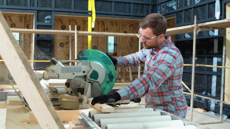 Building Contractor Worker Using Hand Held Worm Drive Circular Saw To ...