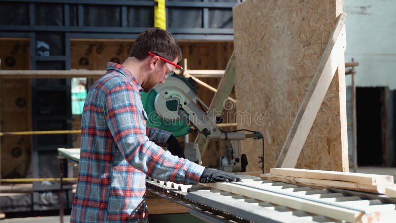 Building Contractor Worker Using Hand Held Worm Drive Circular Saw To ...