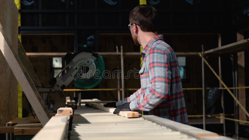 Building Contractor Worker Using Hand Held Worm Drive Circular Saw To ...