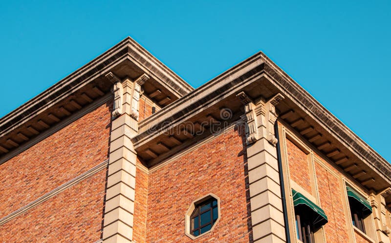 A Building on a Corner with a Clock at the Top Stock Photo - Image of ...