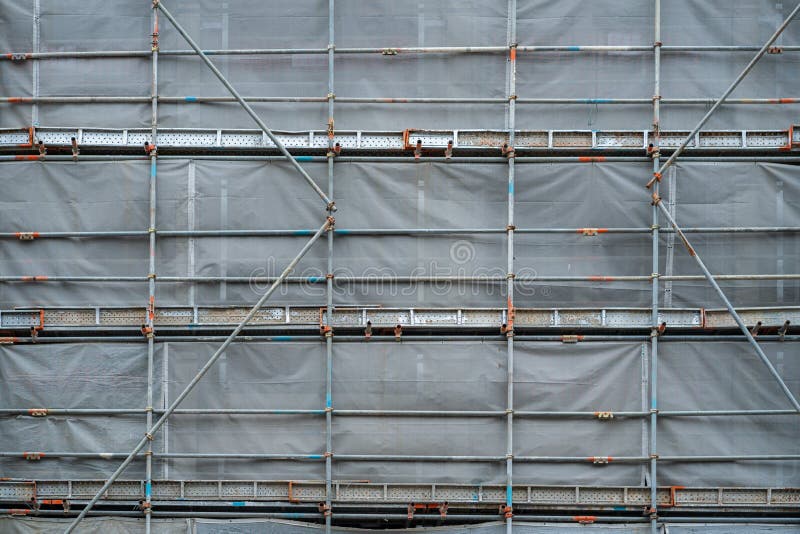 Building Covered with Scaffolds and Grey Mesh. Stock Photo - Image of ...