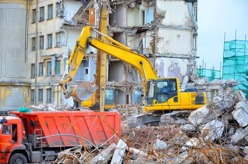 Building Destruction, Demolition of a Building by an Yellow Excavator ...