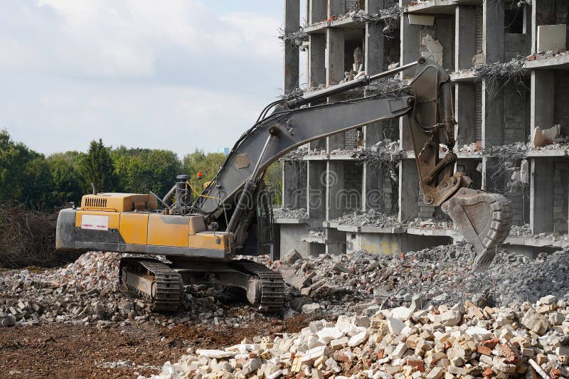 Building Destruction, Demolition of a Building by an Yellow Excavator ...