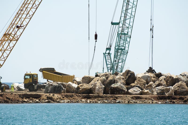 Building a Dike. Cranes and Excavator Put Stones Stock Photo - Image of ...