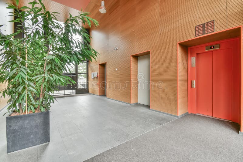 Building Entrance with Bright Red Elevator Stock Photo - Image of real ...