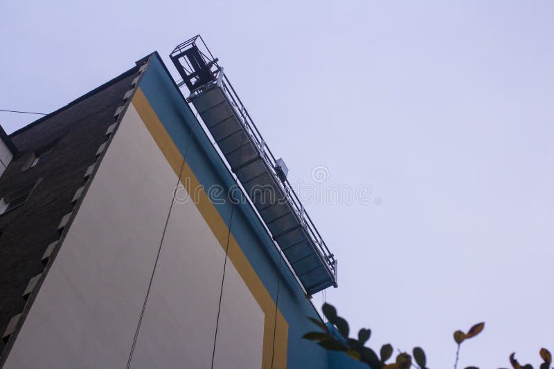 Building Facade Renovation. the Construction Cradle is Suspended for ...